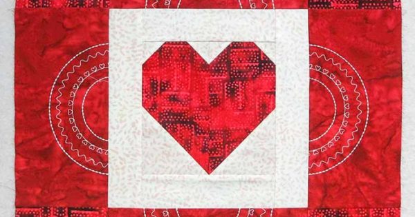 Piecing the heart together on this sweet Valentine-themed quilt